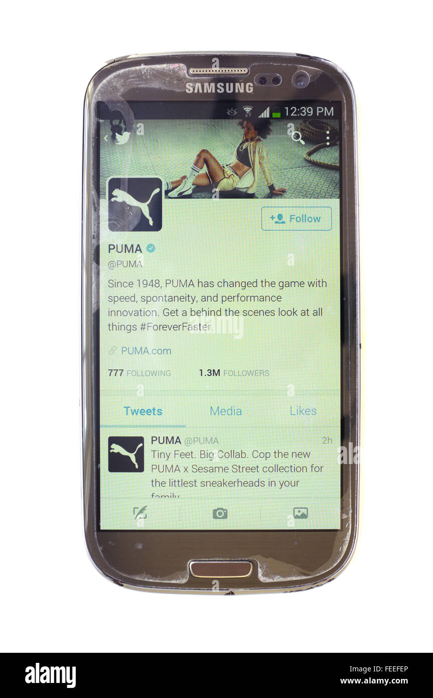 The Puma Twitter page on a smartphone screen photographed against a ...