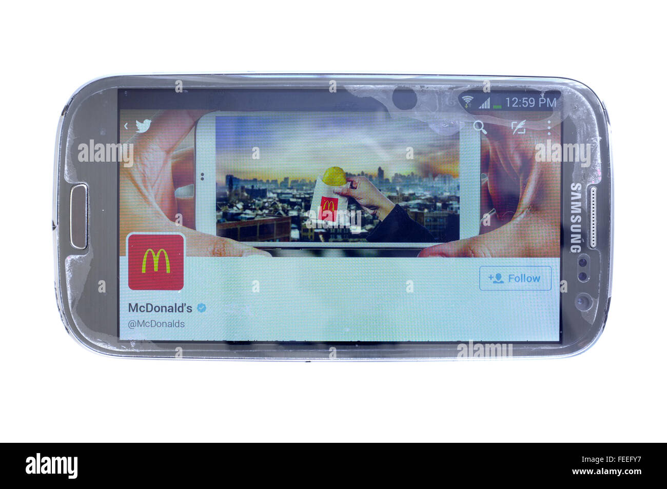 The McDonald's Twitter page on a smartphone screen photographed against ...