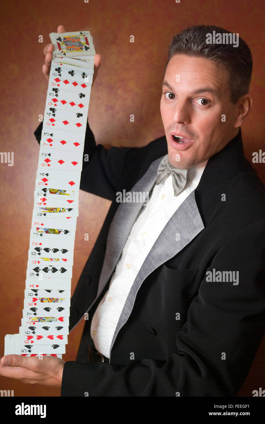 Magician make performance with card deck Stock Photo - Alamy