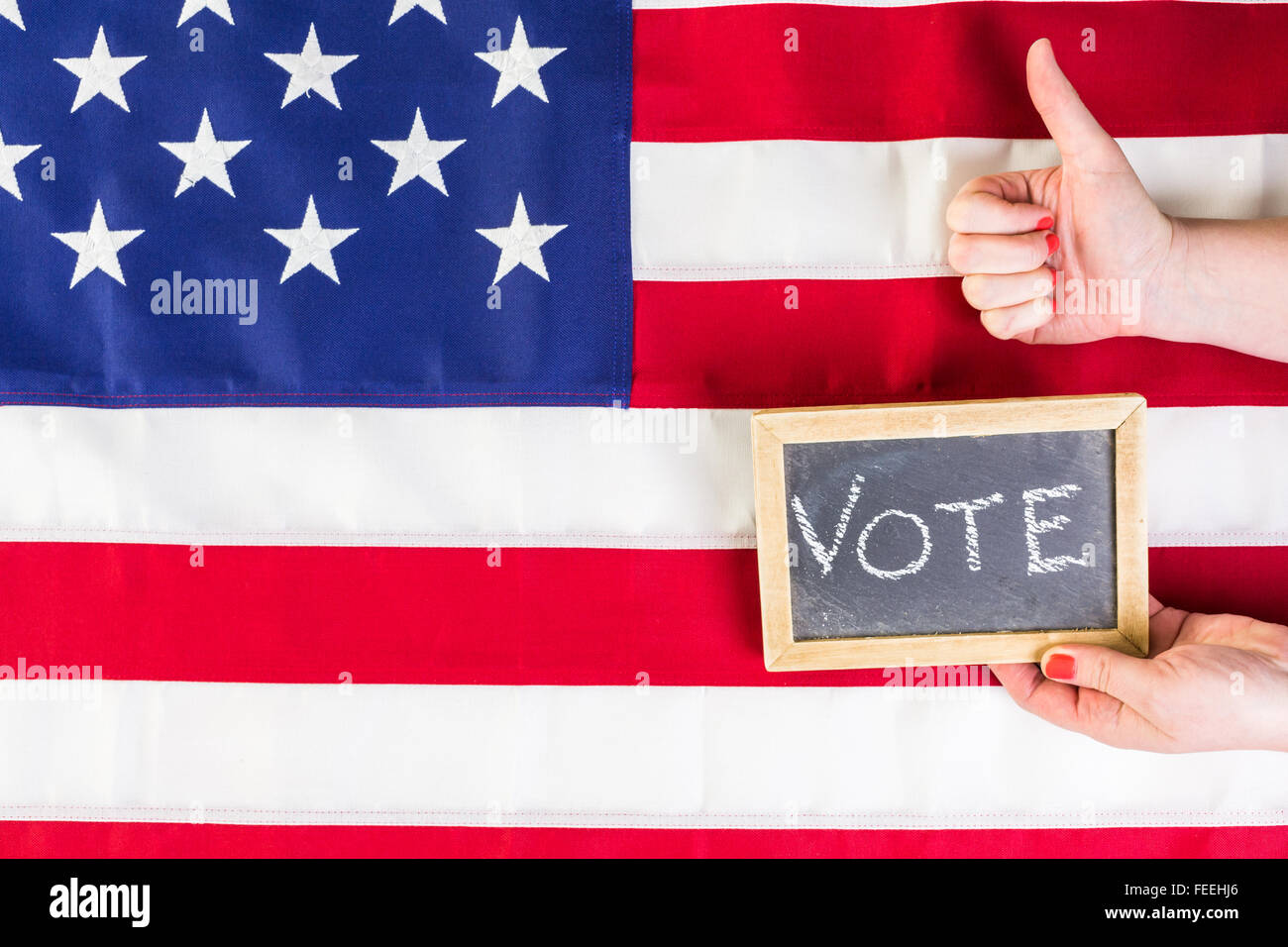 Vote sign on chalk board next to the American Flag Stock Photo - Alamy