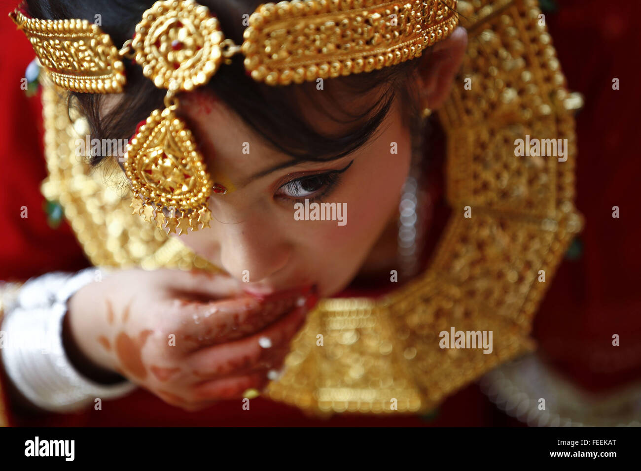 Kathmandu, Nepal. 5th Feb, 2016. A girl eats food after offering prayer ...