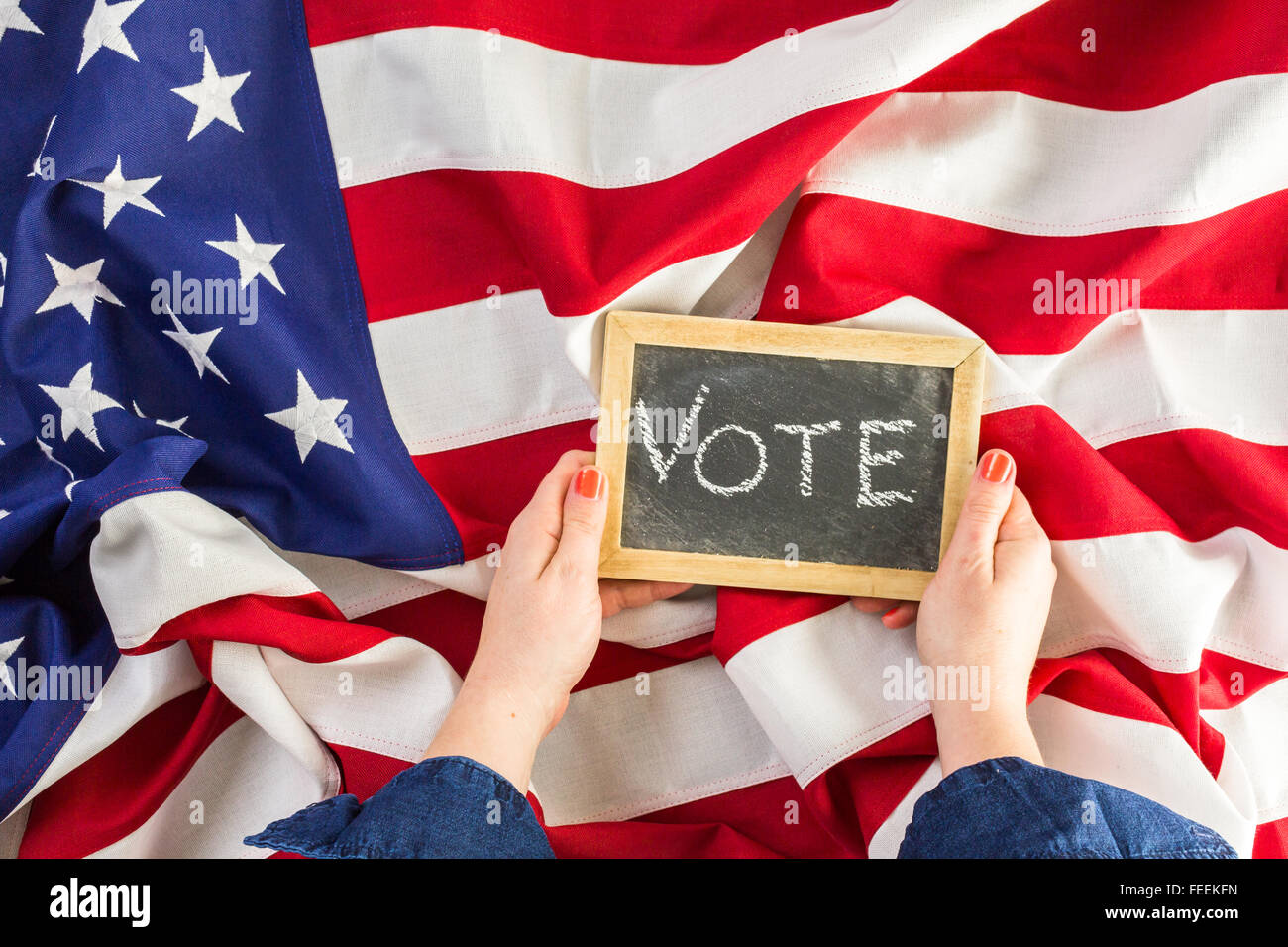 Vote sign on chalk board next to the American Flag Stock Photo - Alamy