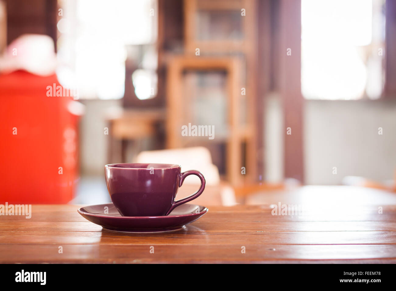 Purple coffee cup on wooden table in coffee shop Stock Photo - Alamy