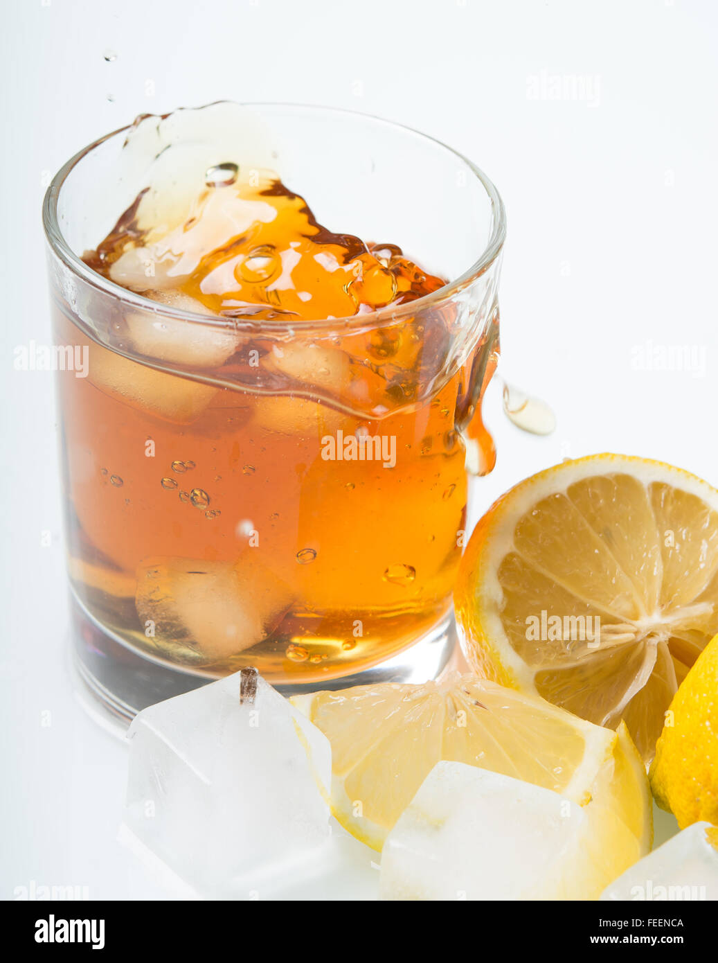 glass of alcohol and ice cubes Stock Photo - Alamy