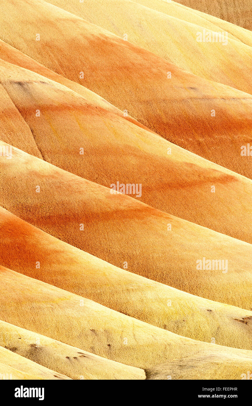 Afternoon sun on the layered folded colorful clay of the Painted Hills ...