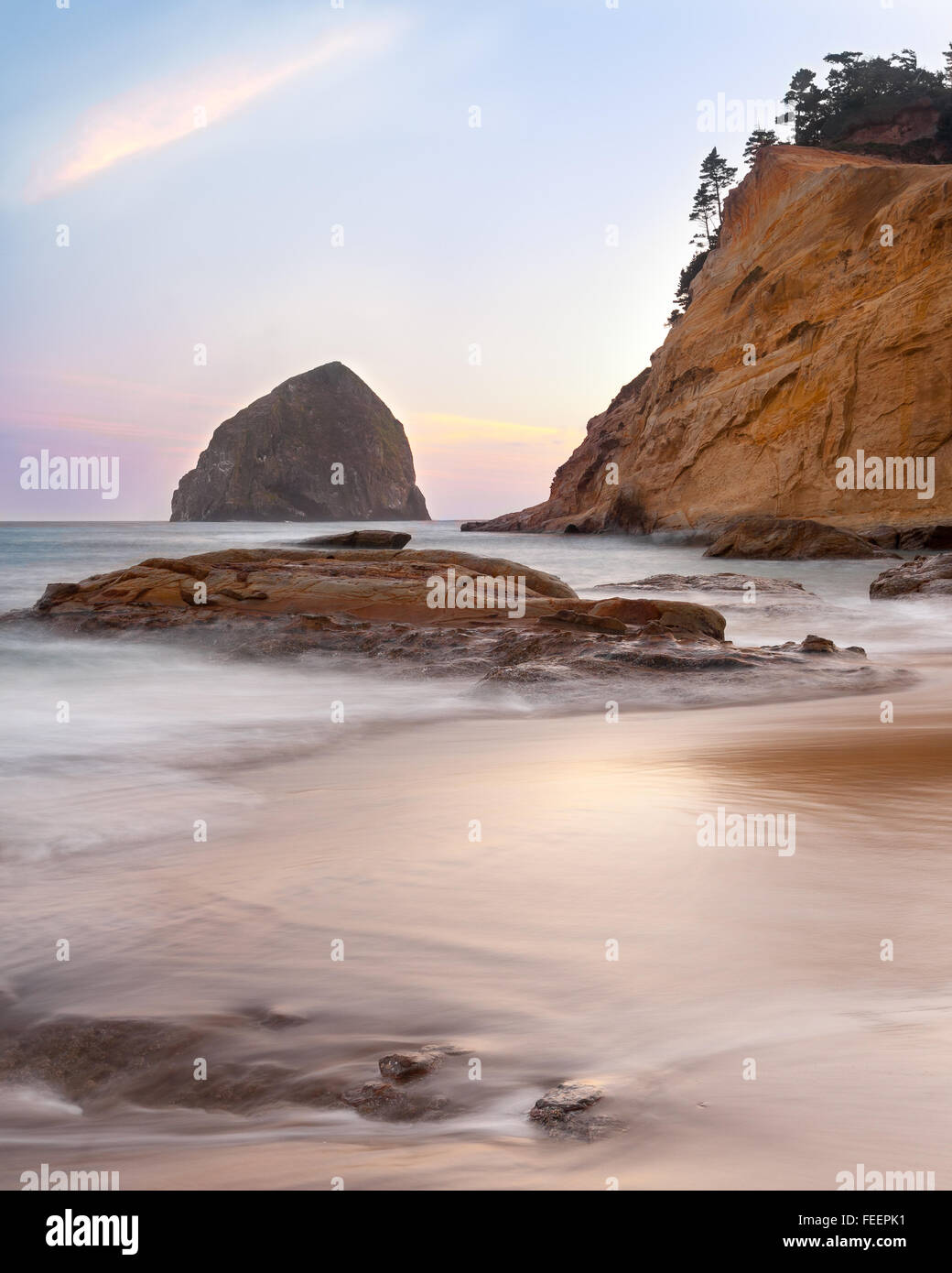 Waves recede from the sands of Kape Kiwanda beach as sea stacks and ...