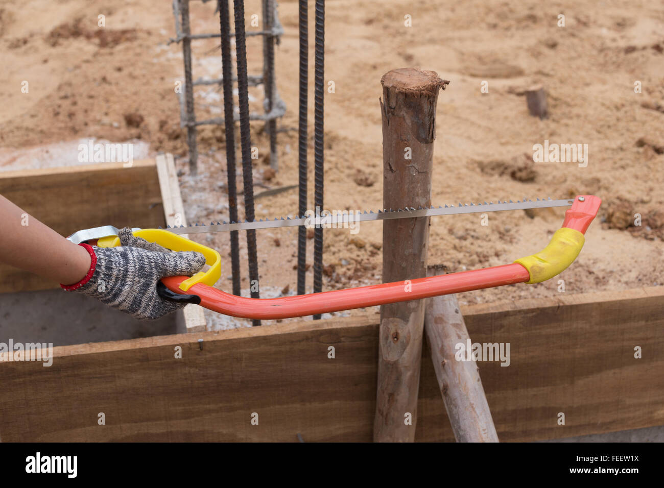 close up of hand cutting wood by hand saw Stock Photo - Alamy