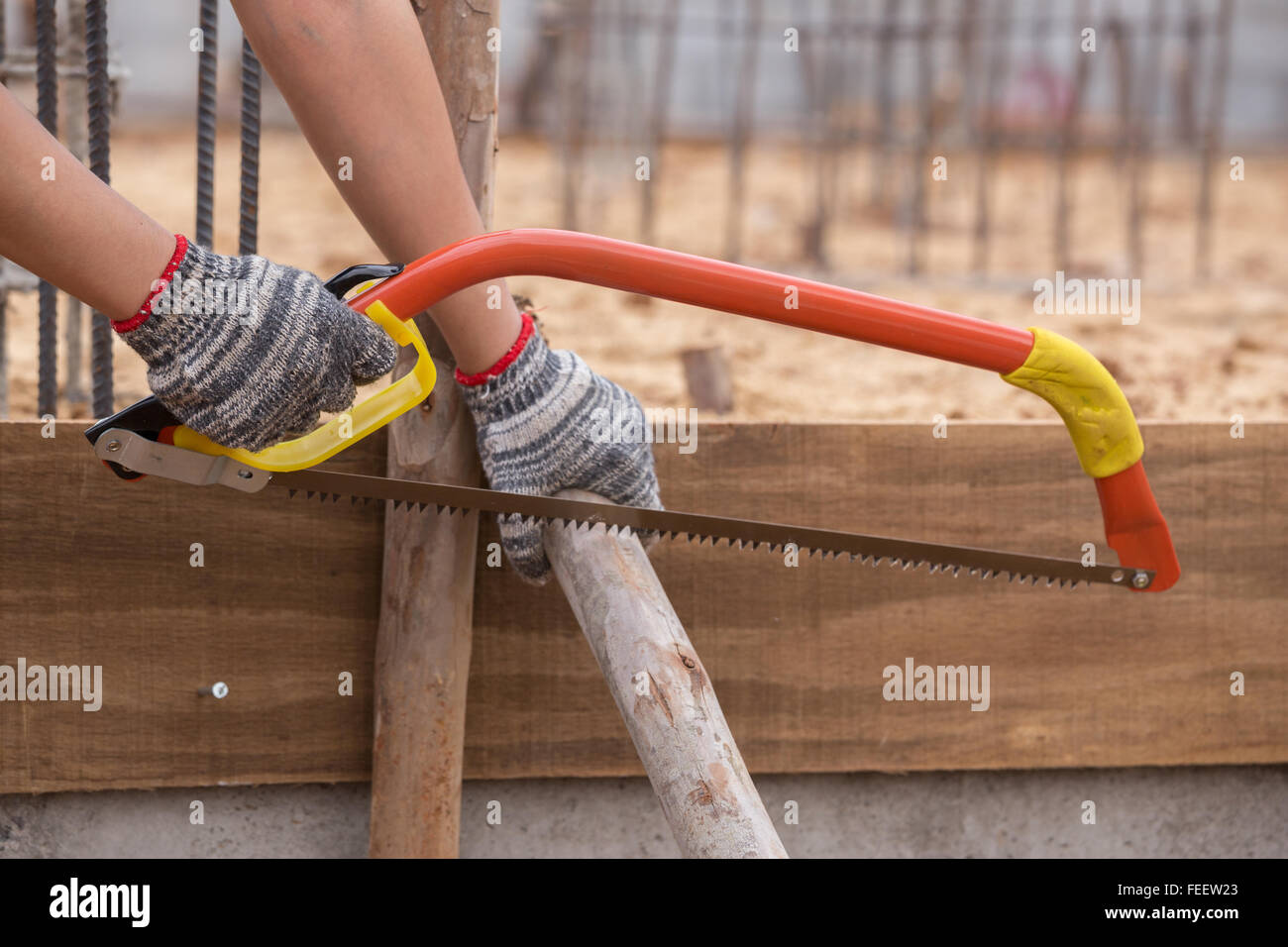 close up of hand cutting wood by hand saw Stock Photo - Alamy