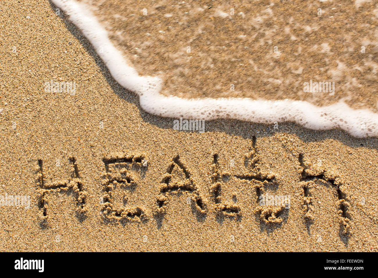 Health - inscription on sand beach with the soft wave Stock Photo - Alamy