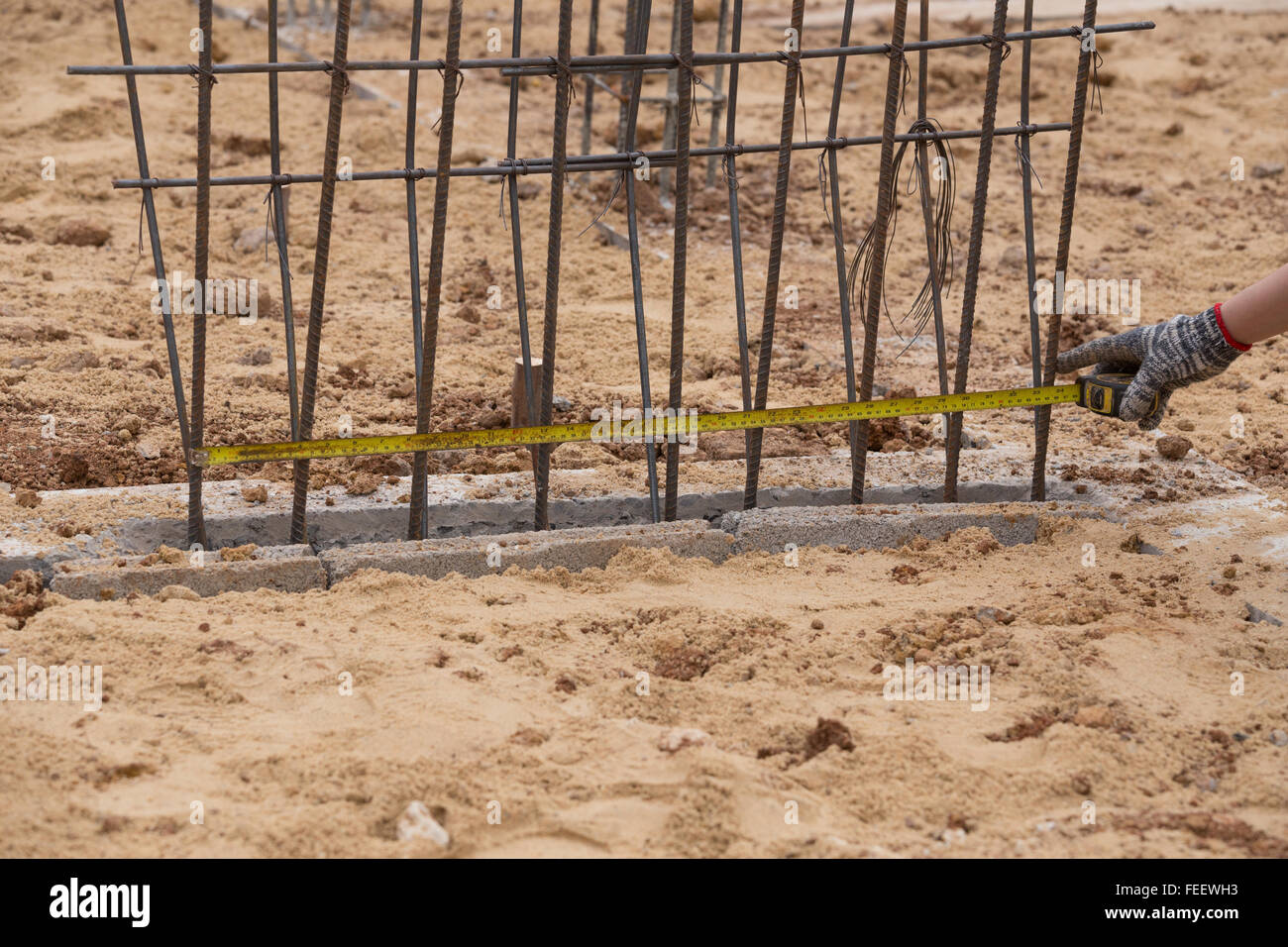 worker measuring steel rod at construction site with tape measure Stock ...