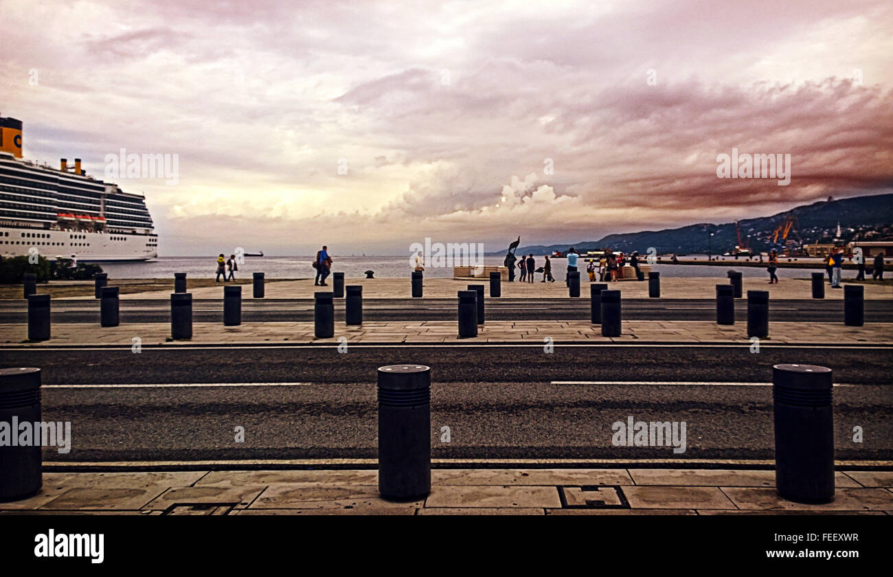 Trieste, Italy - sea waterfront promenade Le Rive at dusk with people ...