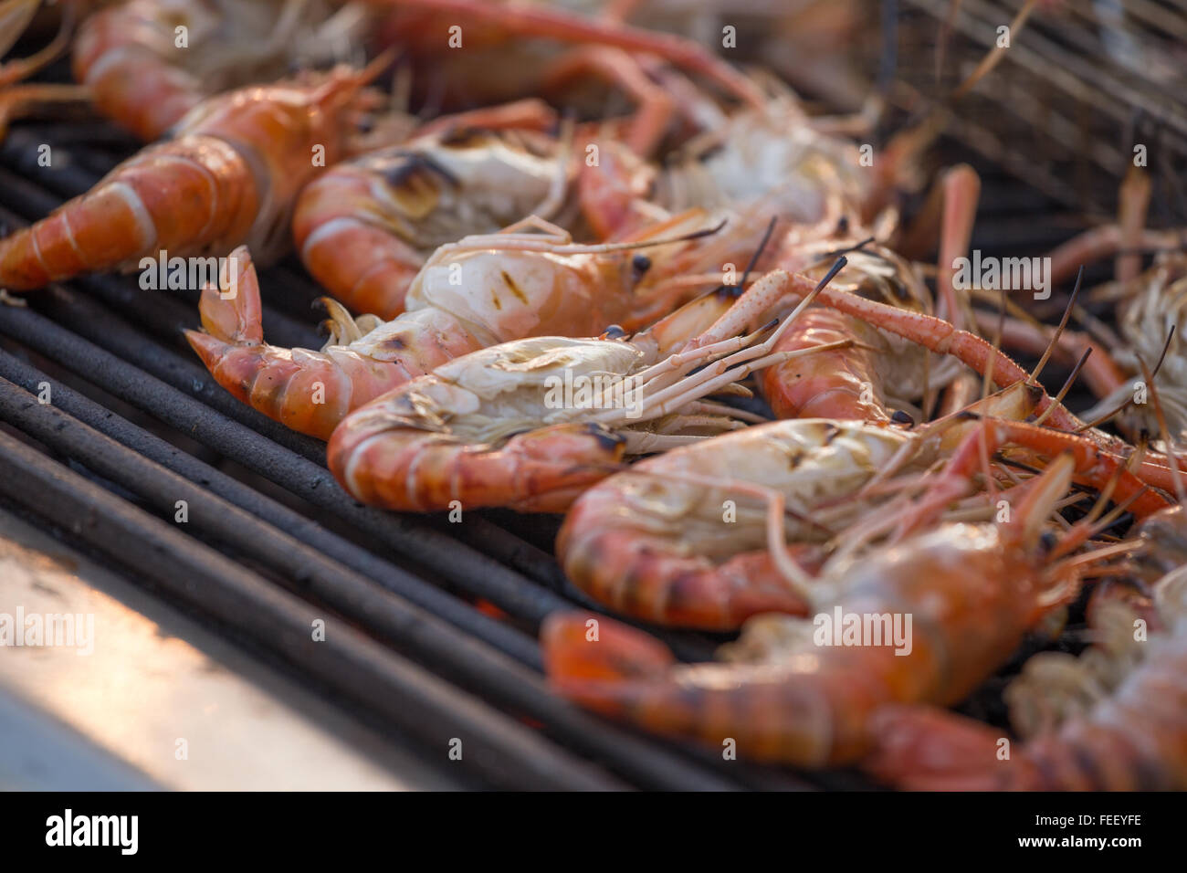 Grilled shrimps seafood by fire and BBQ Flames at market Stock Photo ...