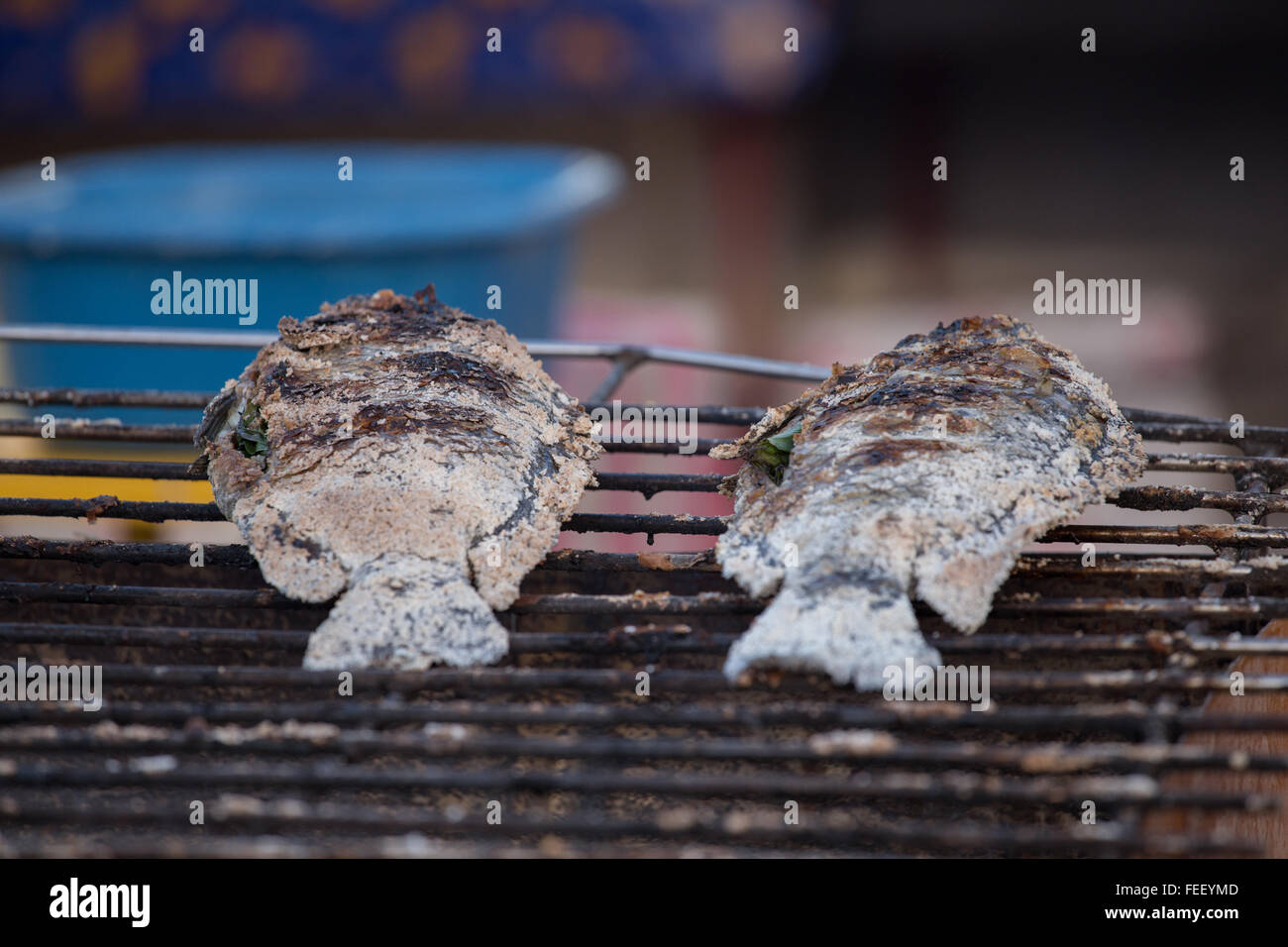 fresh delicious grilled fish, tilapia, nile fish with salt at market ...