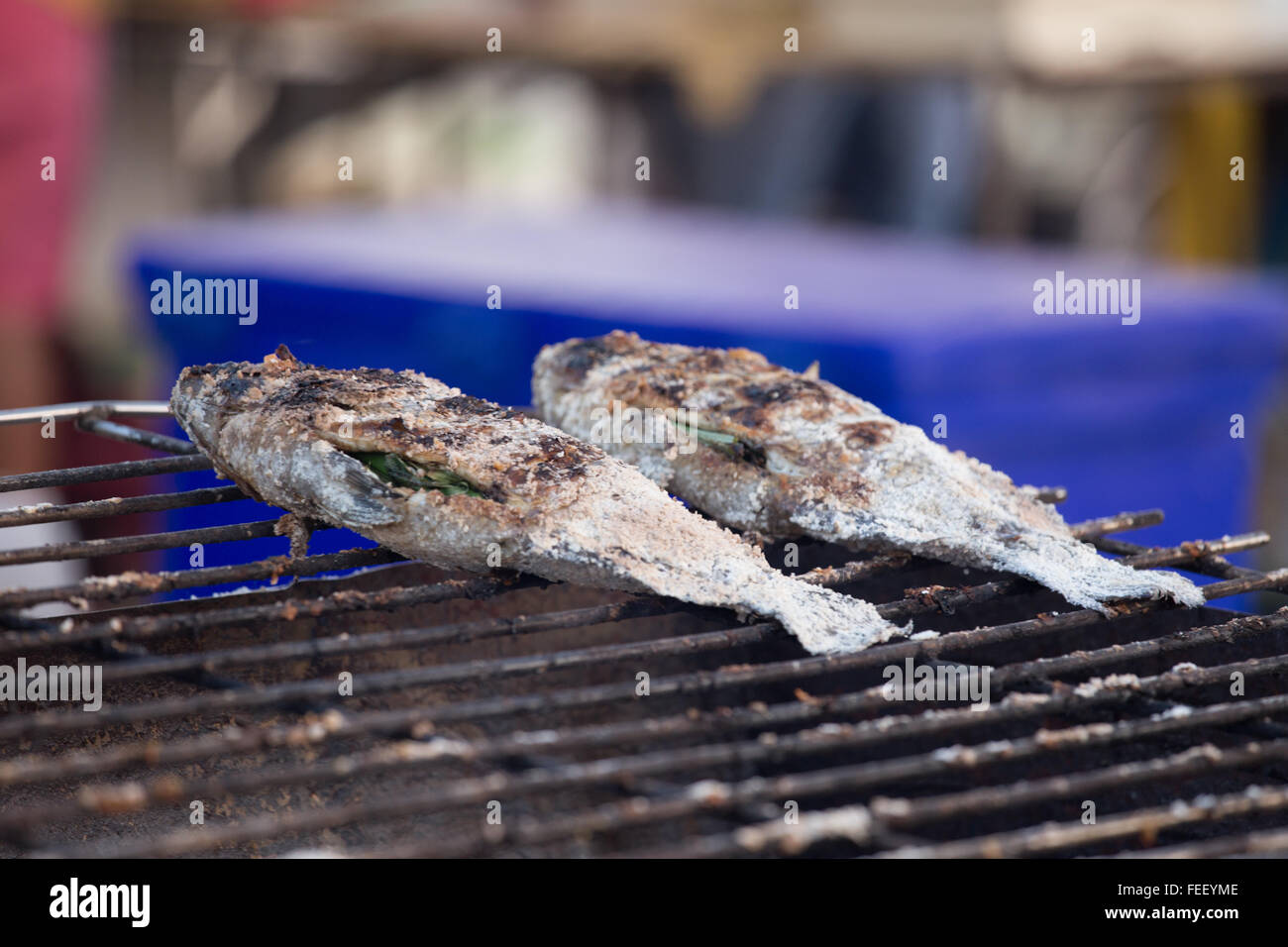 fresh delicious grilled fish, tilapia, nile fish with salt at market ...