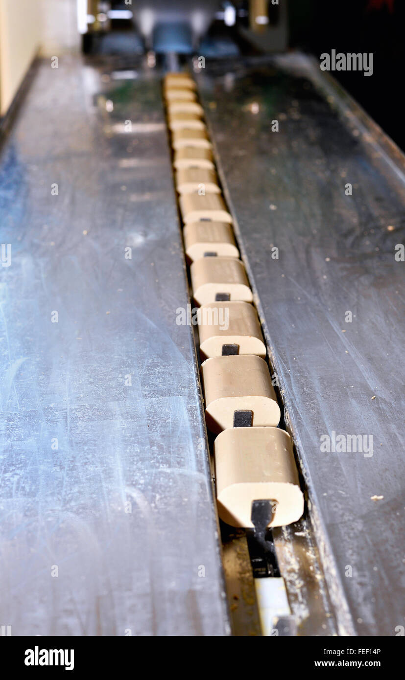 Pieces of soap on the assembly line at the plant for the production of ...