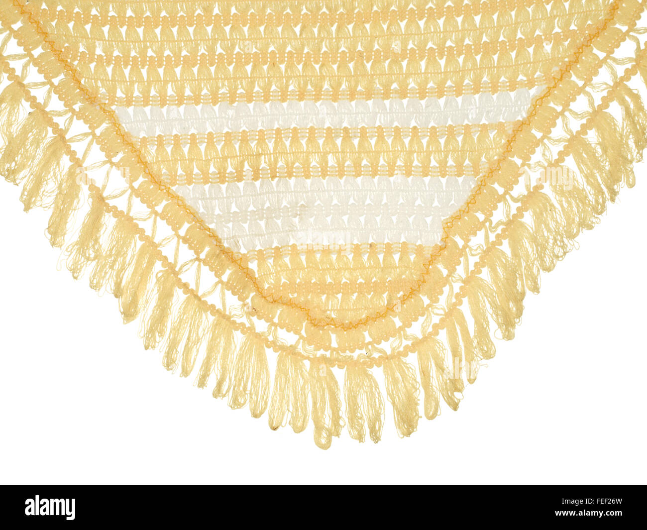 Part of an old tablecloth with fringe isolated on white background ...