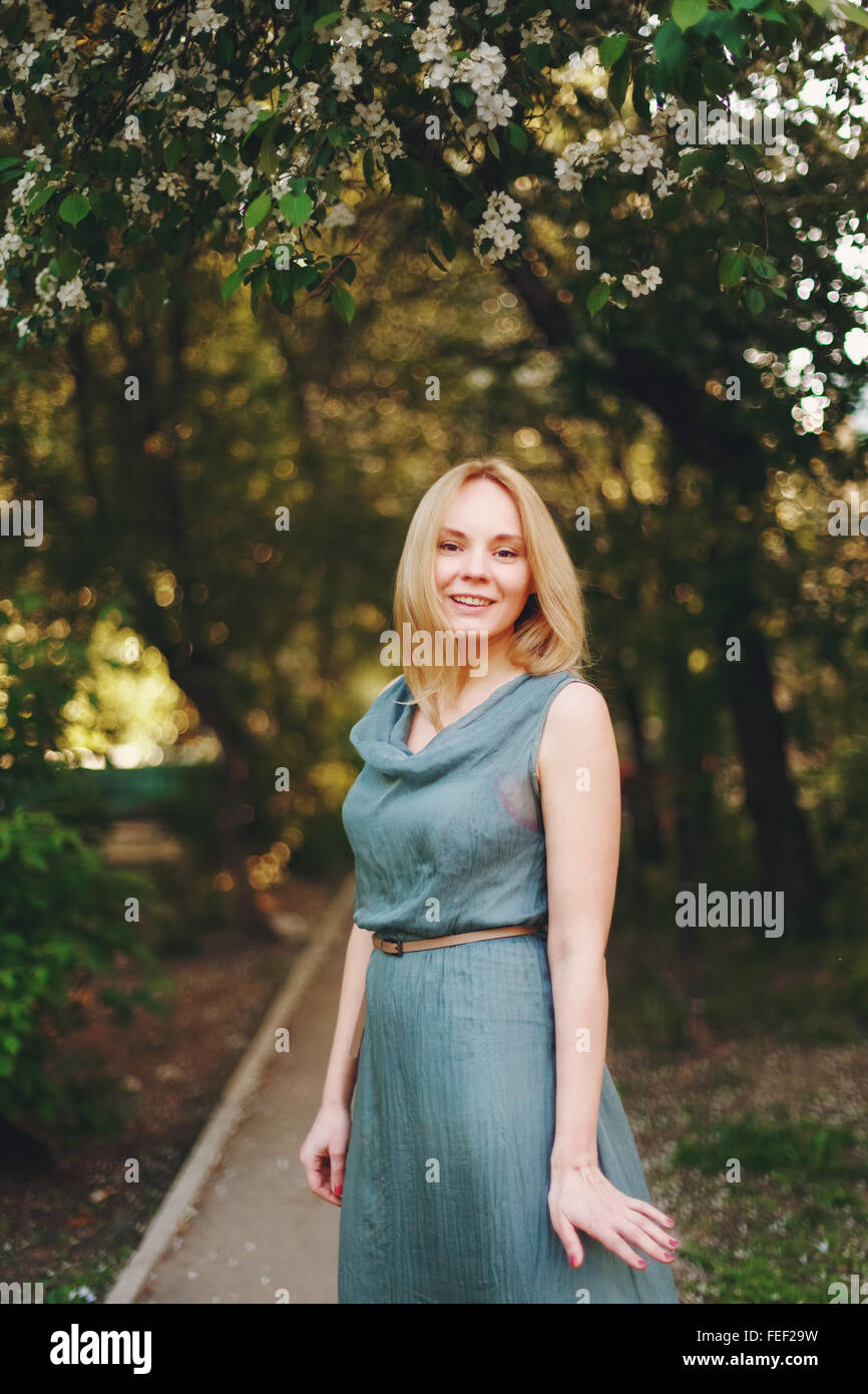 Young Beautiful Female Laughing. Spring Outdoor Portrait with Blooming ...