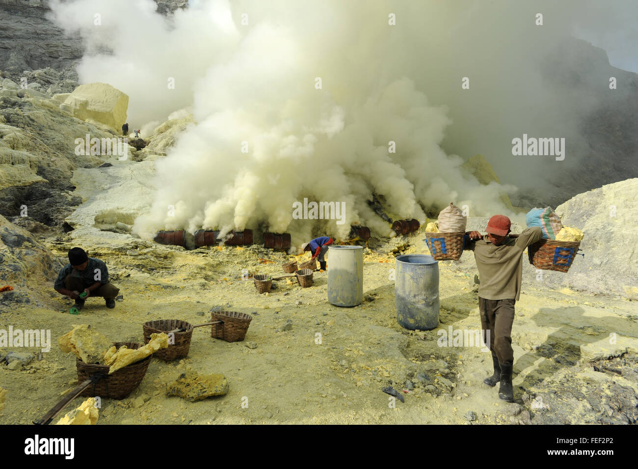 People collecting sulfur from the crater of the volcano Ijen on the ...