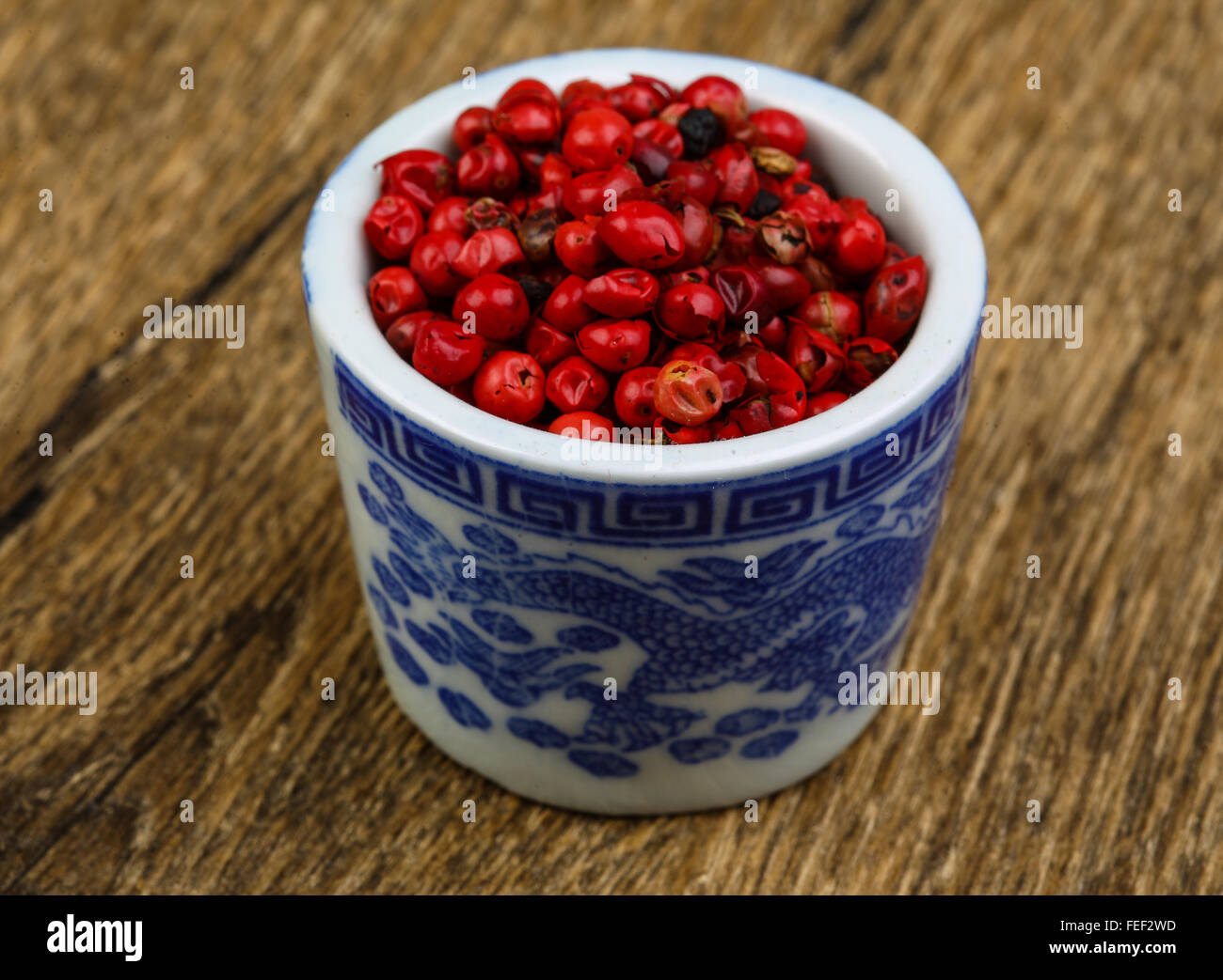 Dry Rose pepper corn on the wood background Stock Photo - Alamy