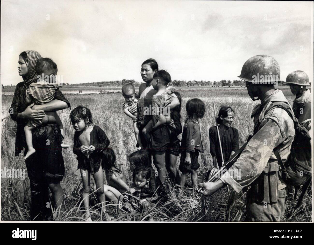 1967 - Vietnam. Vietnamese family crossing the fire line in guerilla ...