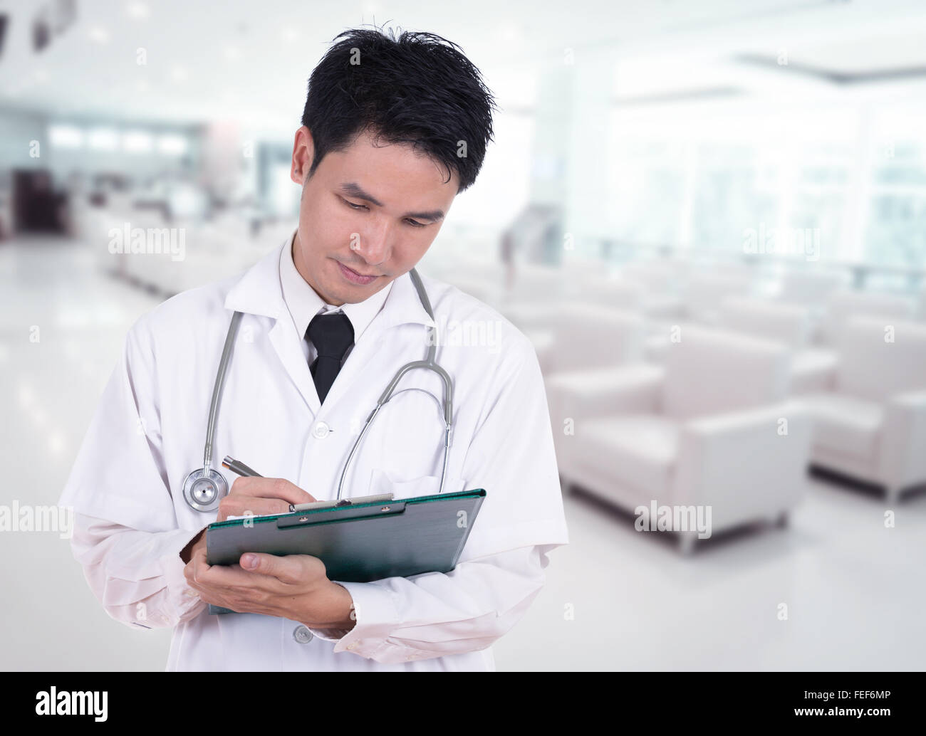 doctor writting medical report in hospital background Stock Photo - Alamy