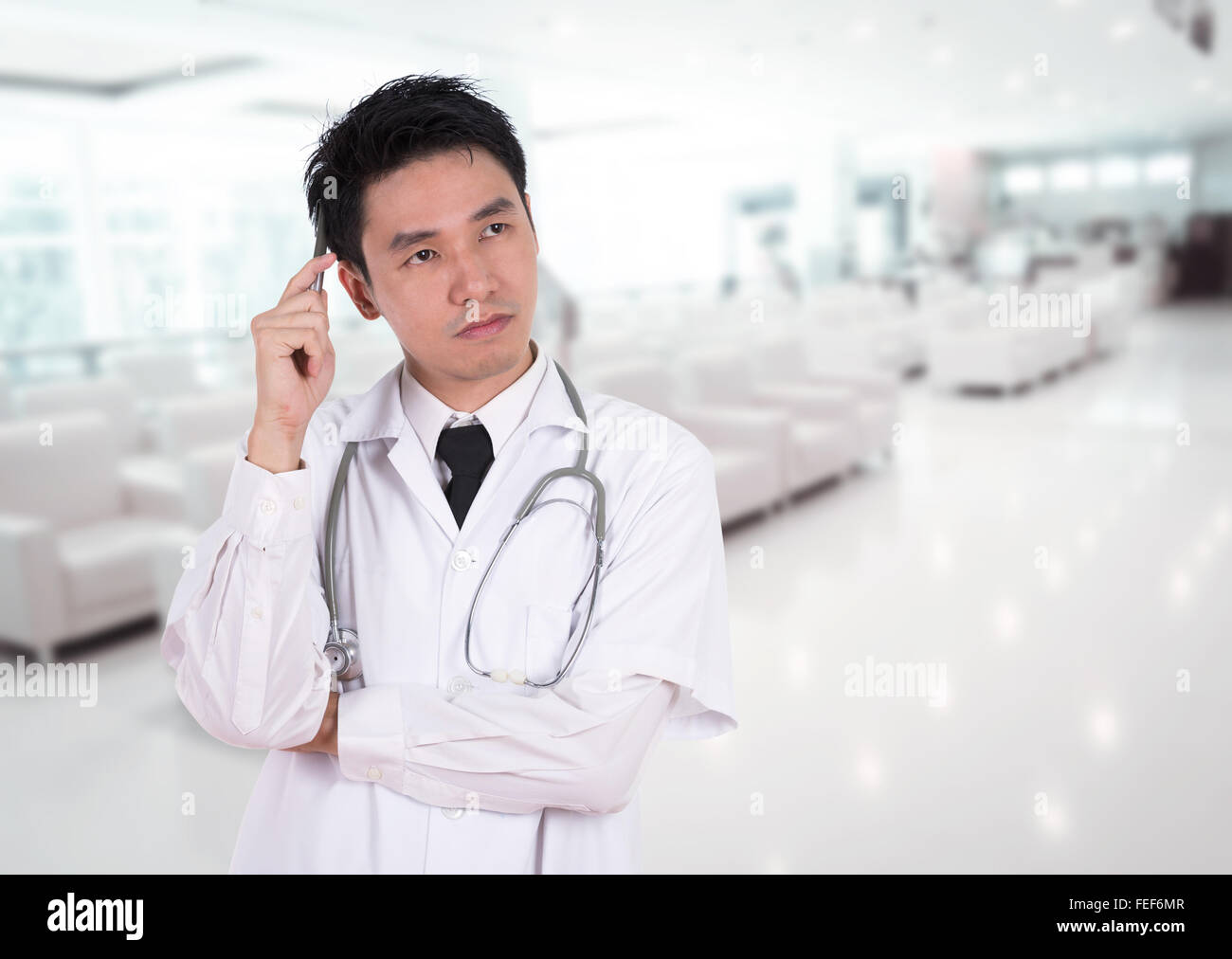 male doctor thinking in hospital background Stock Photo - Alamy