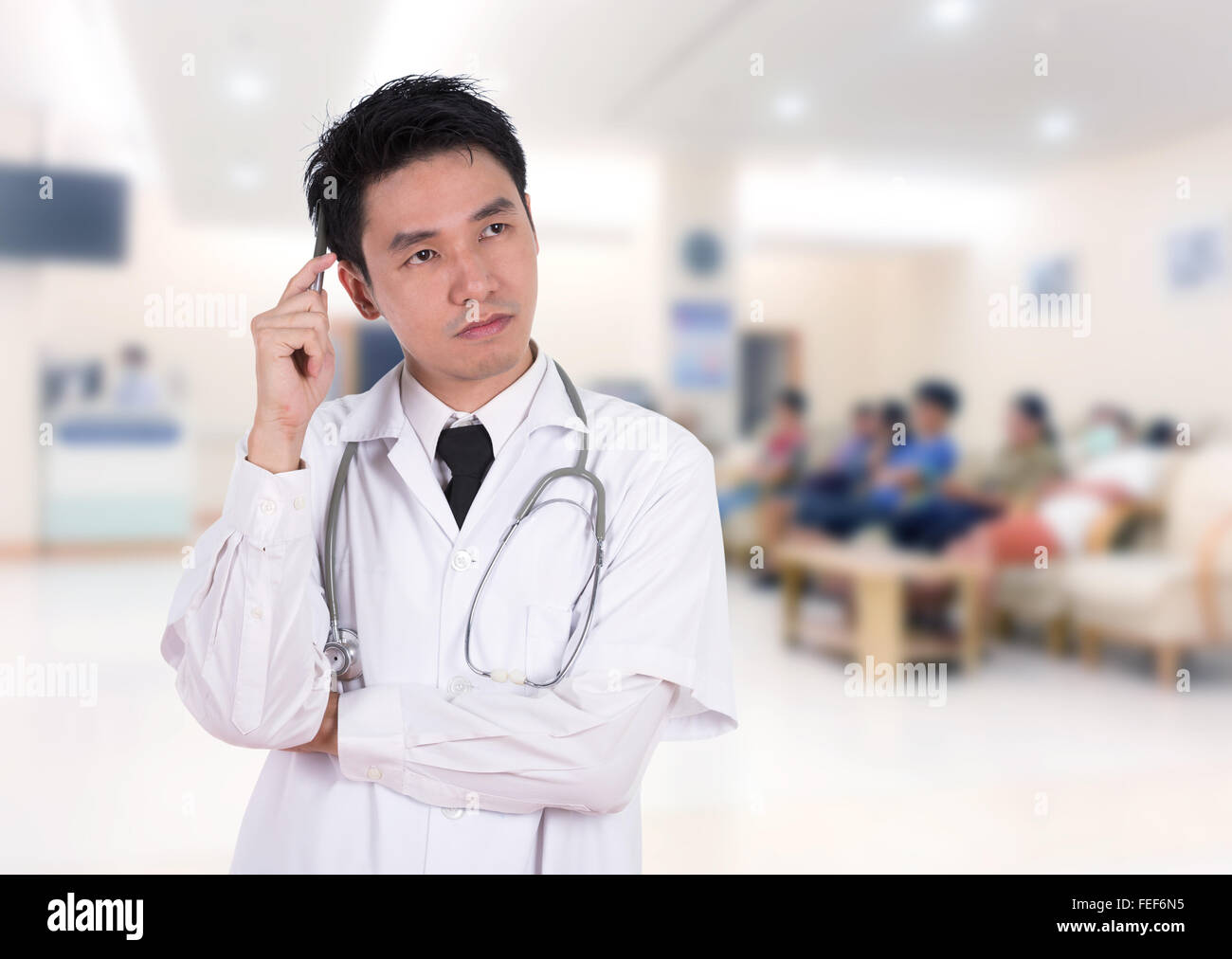 male doctor thinking in hospital background Stock Photo - Alamy