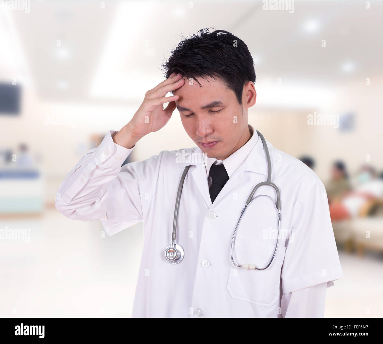 Doctor hold the head with hand, worried, strain , headache in hospital ...