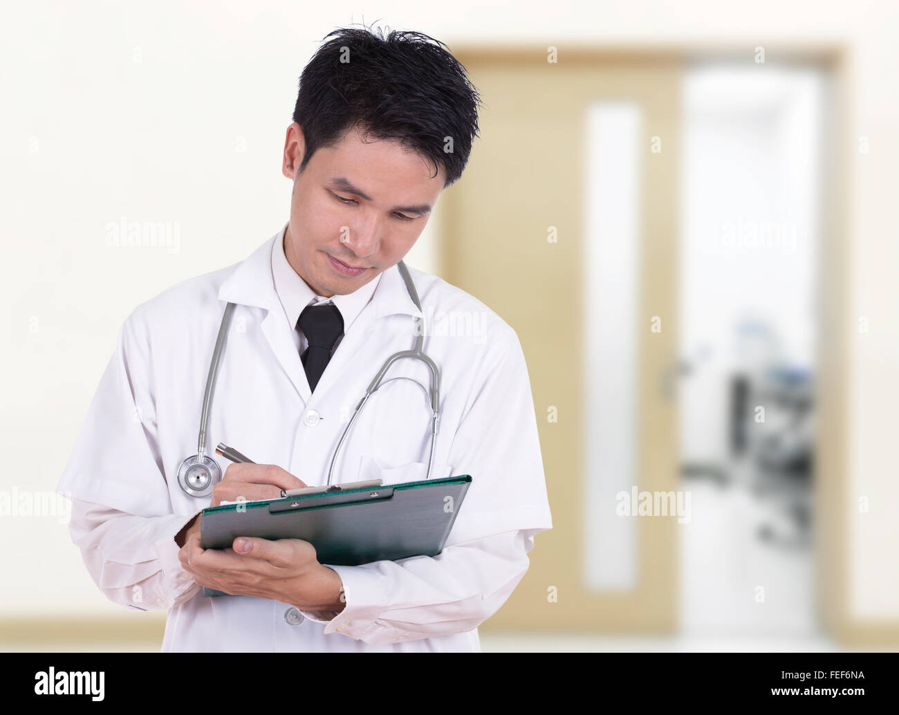 doctor writting medical report in hospital background Stock Photo - Alamy