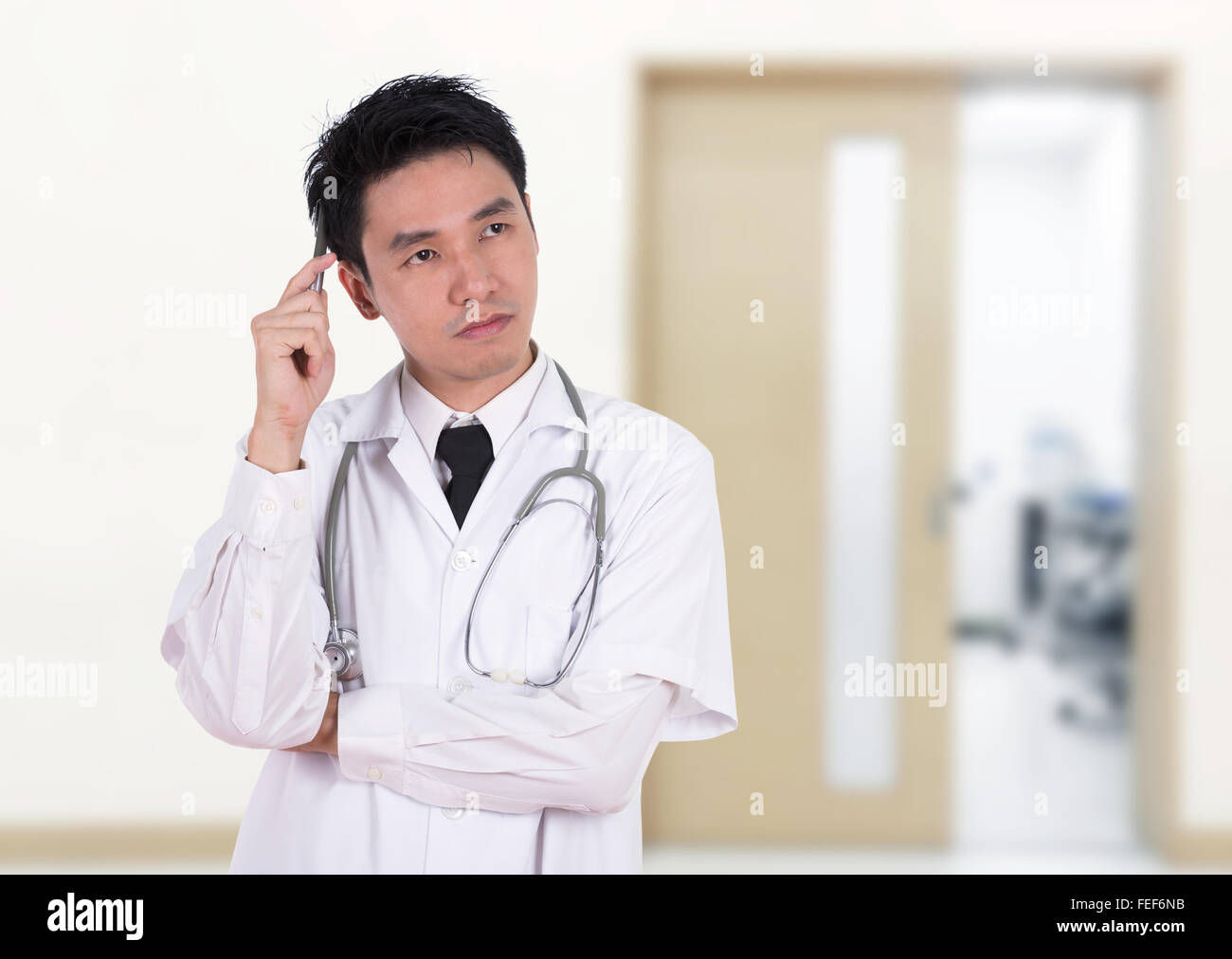 Asian doctor thinking in white hi-res stock photography and images - Alamy