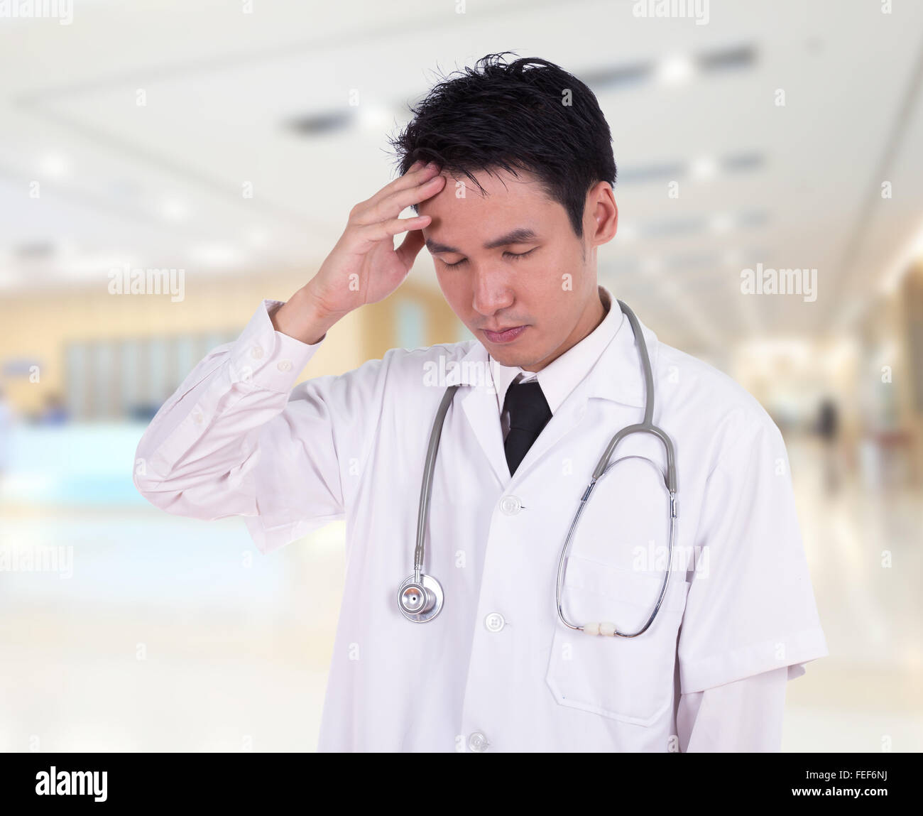 Doctor hold the head with hand, worried, strain , headache in hospital ...