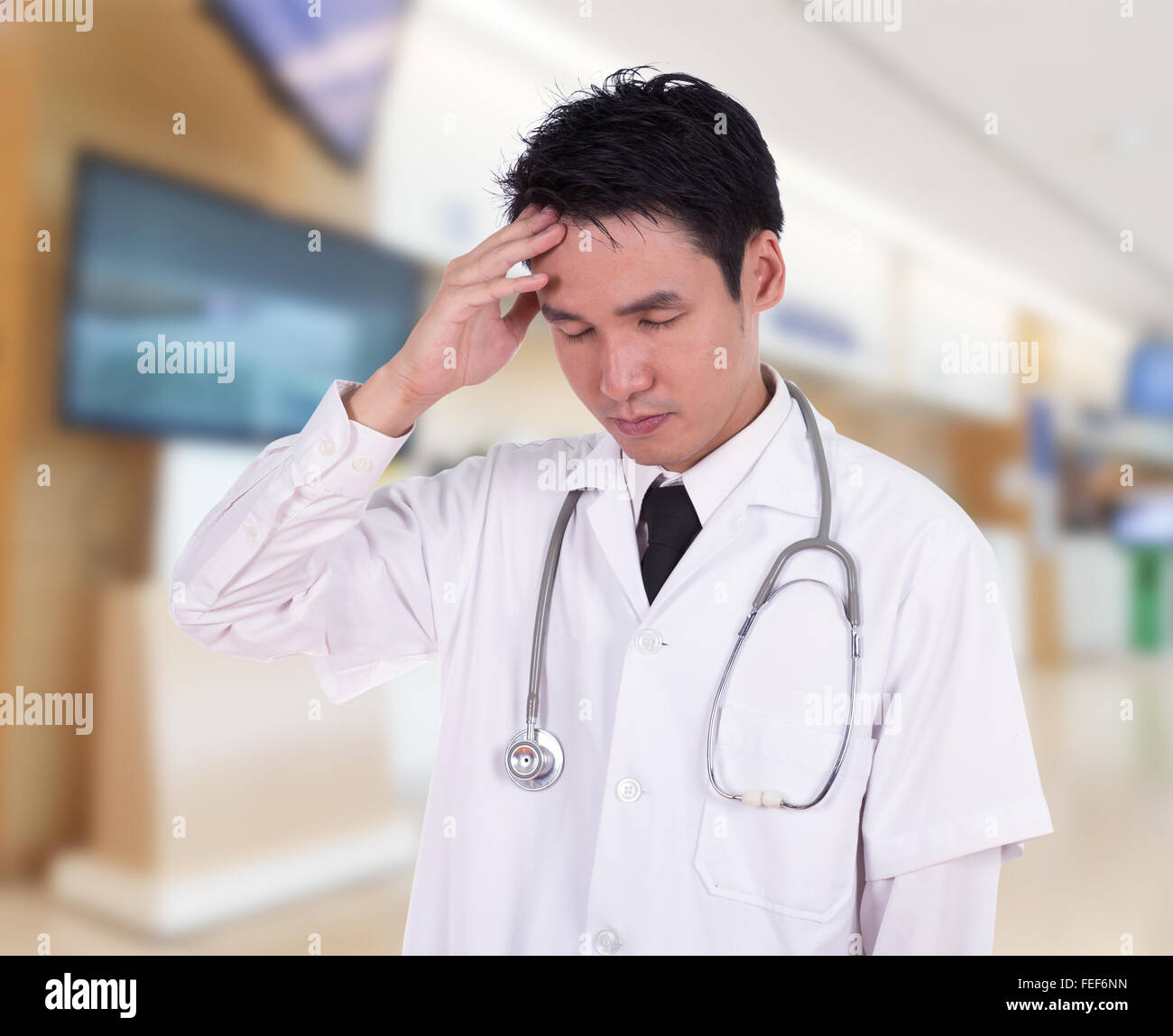 Doctor hold the head with hand, worried, strain , headache in hospital ...