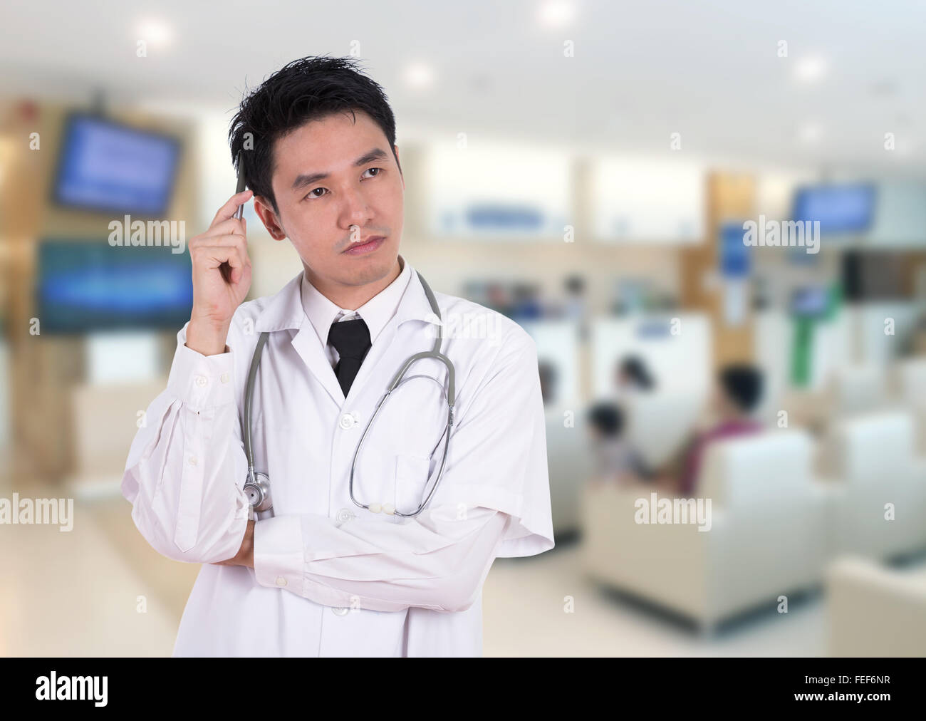 male doctor thinking in hospital background Stock Photo - Alamy