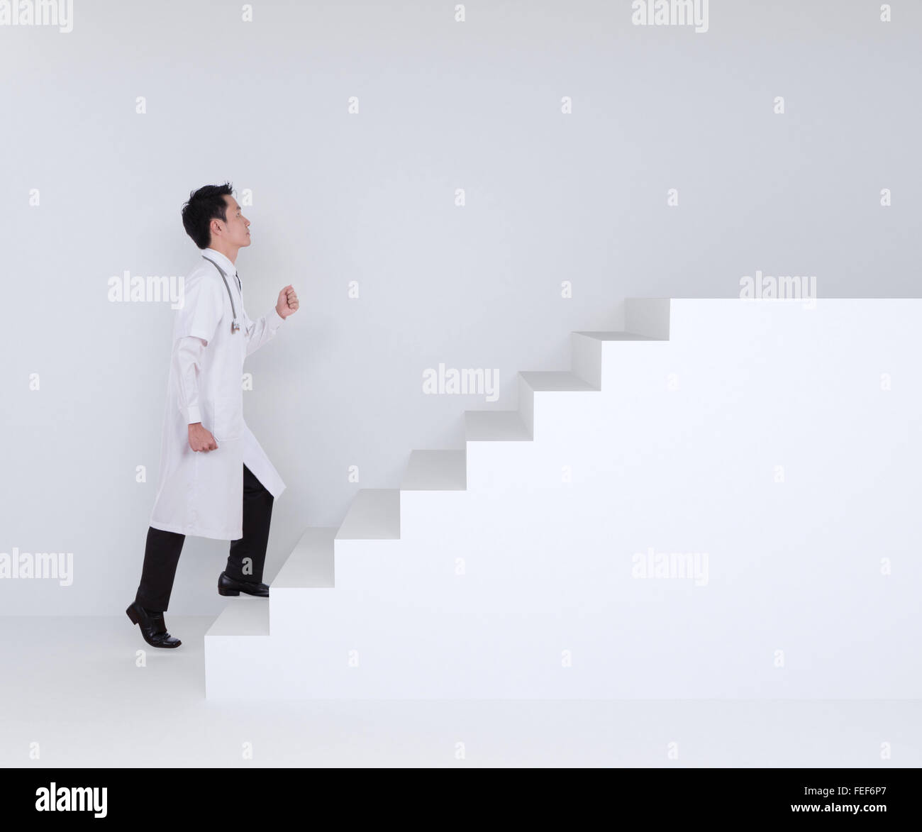 male doctor stepping up on white stairs Stock Photo - Alamy