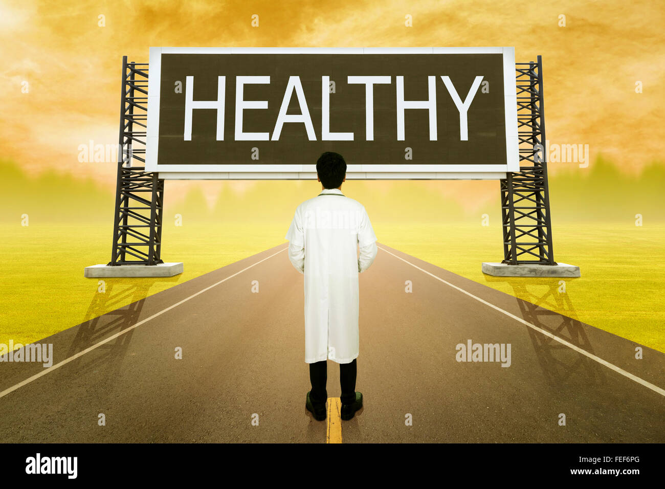 male doctor standing on road and looking with large sign of healthy at ...