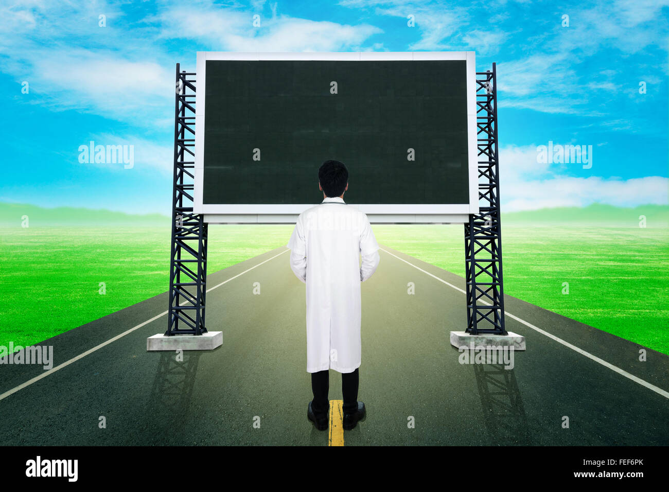 male doctor standing on road and looking with empty large sign Stock ...