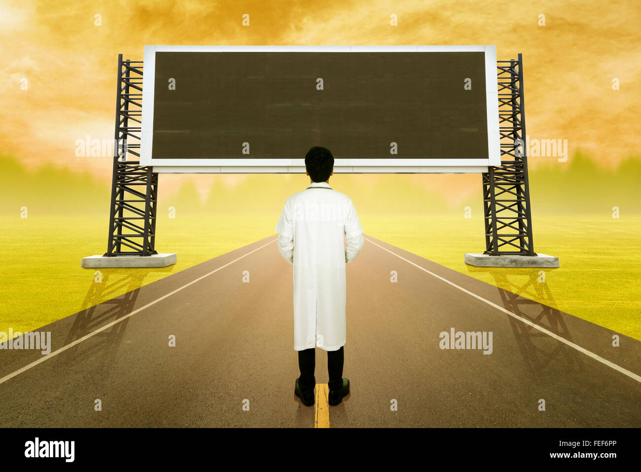 male doctor standing on road and looking with empty large sign at ...