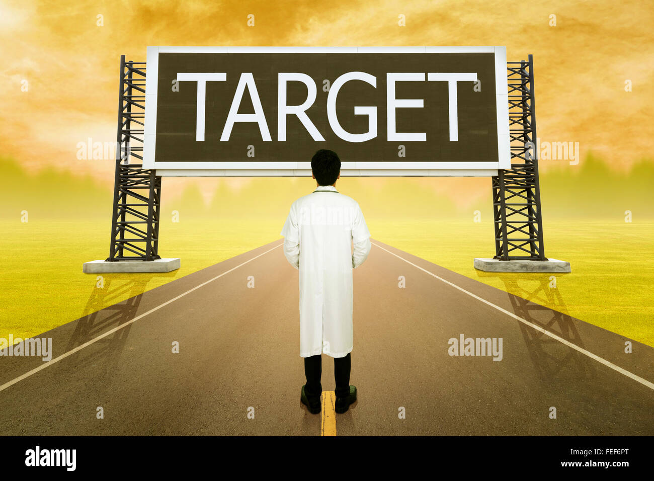 male doctor standing on road and looking with large sign of target at ...