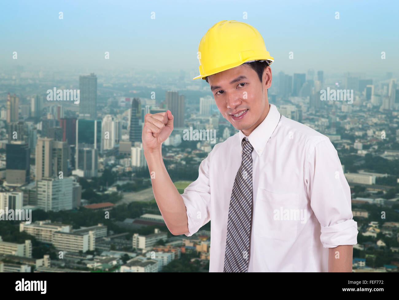 Happy engineer celebrating with arm raised, concept of successful, city ...