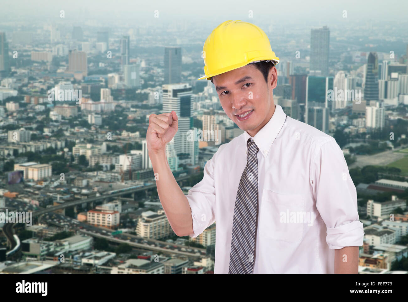Happy engineer celebrating with arm raised, concept of successful, city ...