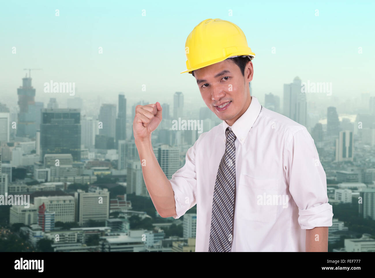 Happy engineer celebrating with arm raised, concept of successful, city ...