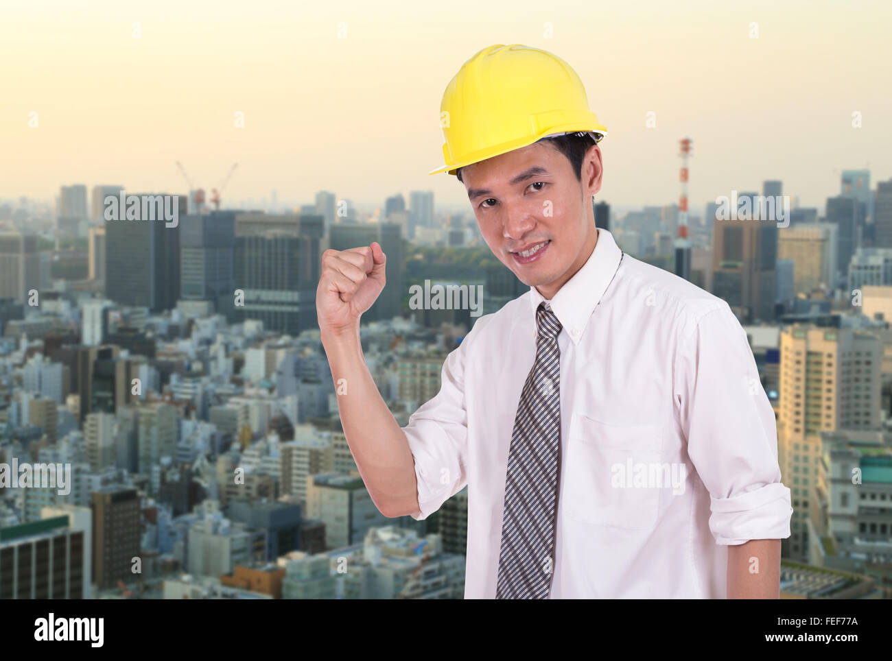 Happy engineer celebrating with arm raised, concept of successful, city ...