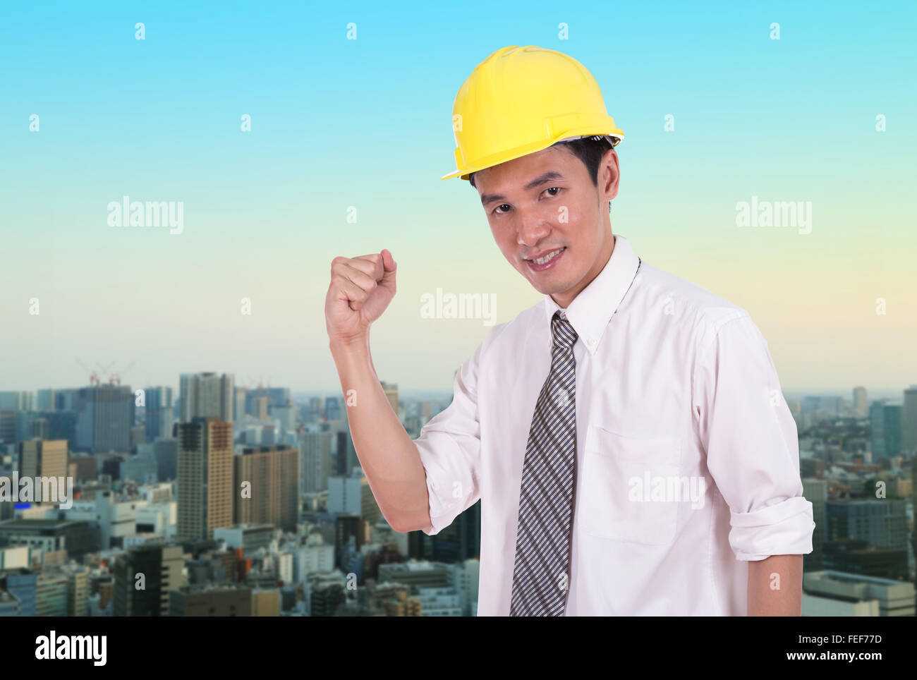 Happy engineer celebrating with arm raised, concept of successful, city ...