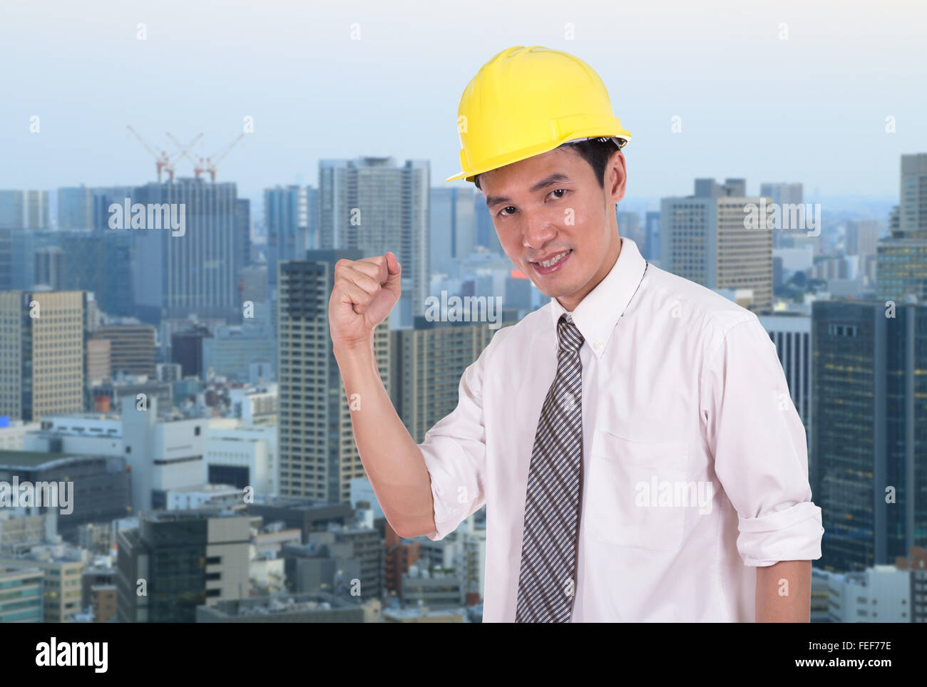Happy engineer celebrating with arm raised, concept of successful, city ...
