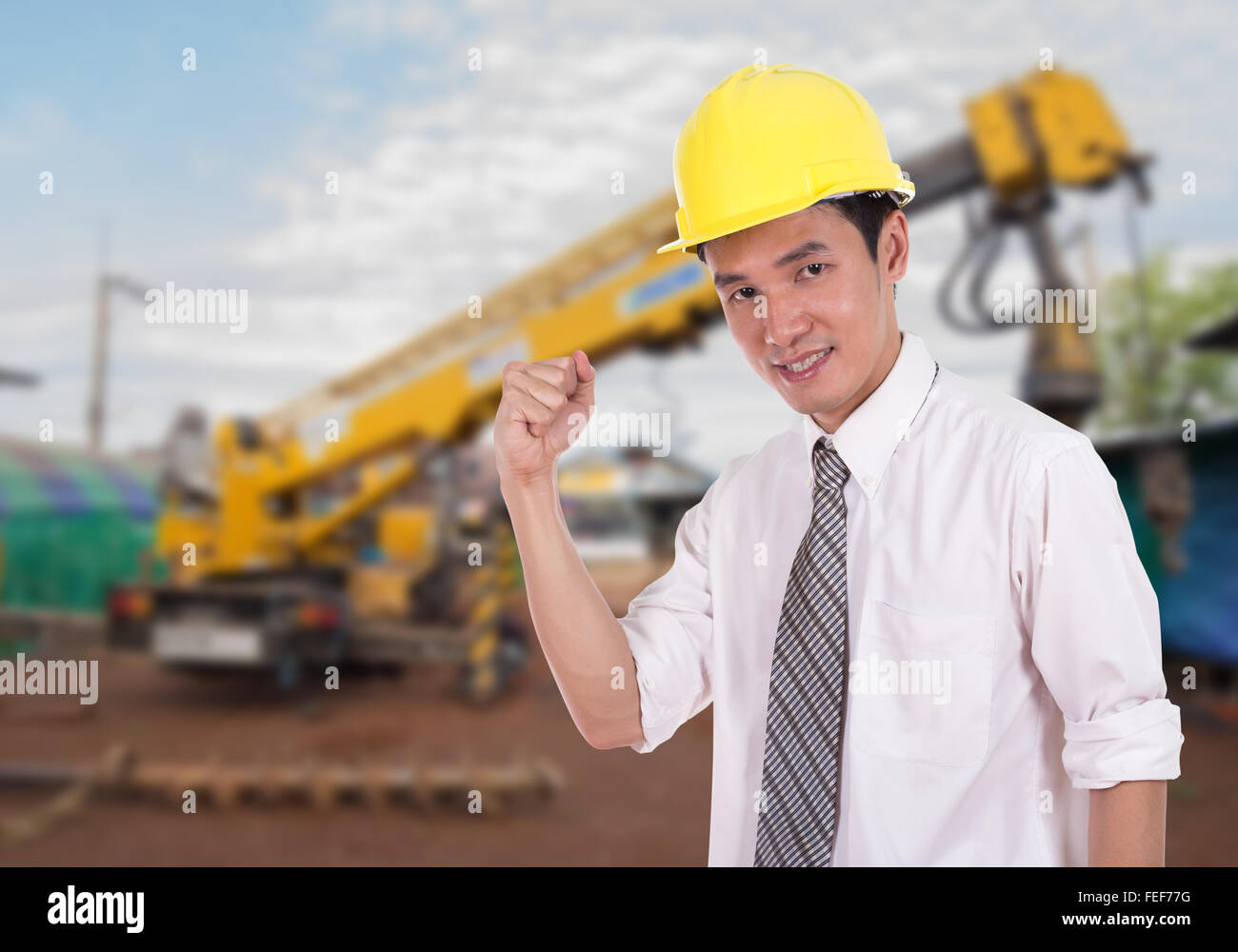 Happy engineer celebrating with arm raised, concept of successful ...