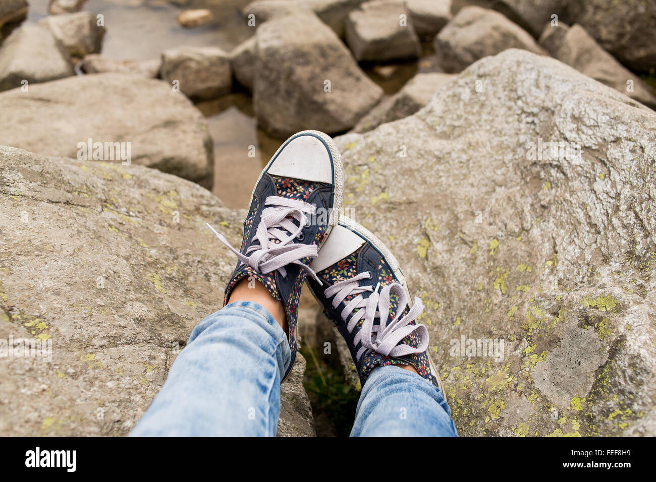 Woman resting on rocks hi-res stock photography and images - Alamy
