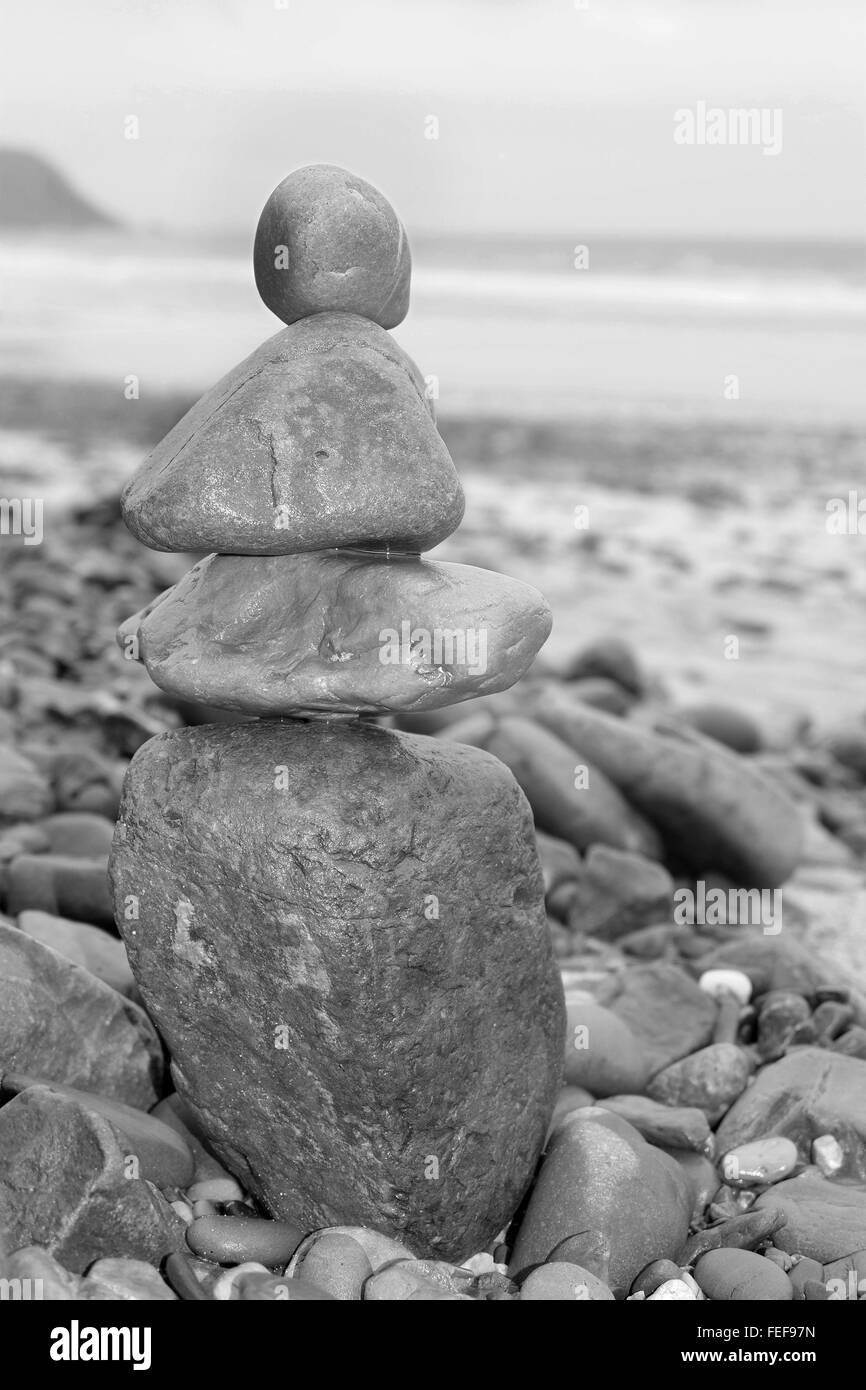 Piles of rocks balanced on top of each other on teh beach at Marloes in ...