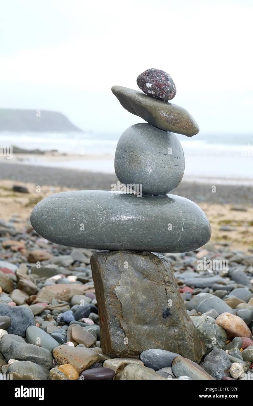 Piles of rocks balanced on top of each other on teh beach at Marloes in ...
