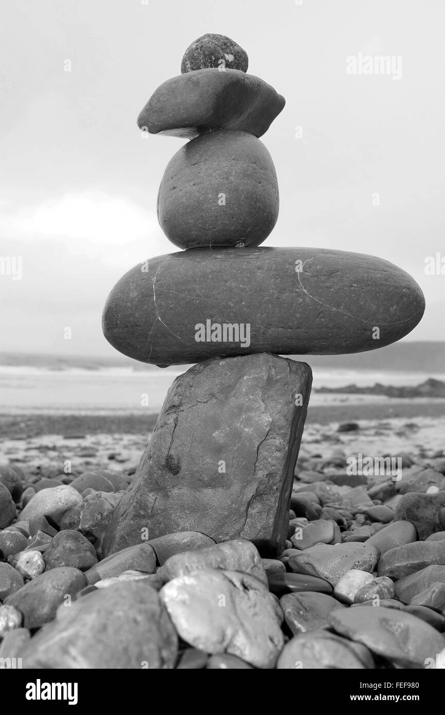 Piles of rocks balanced on top of each other on teh beach at Marloes in ...