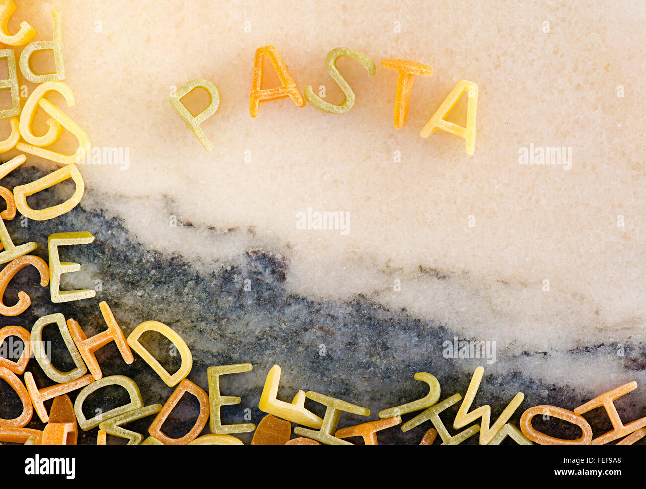 Multi Colored Pasta letters spelling Pasta on a marble slab, with an ...